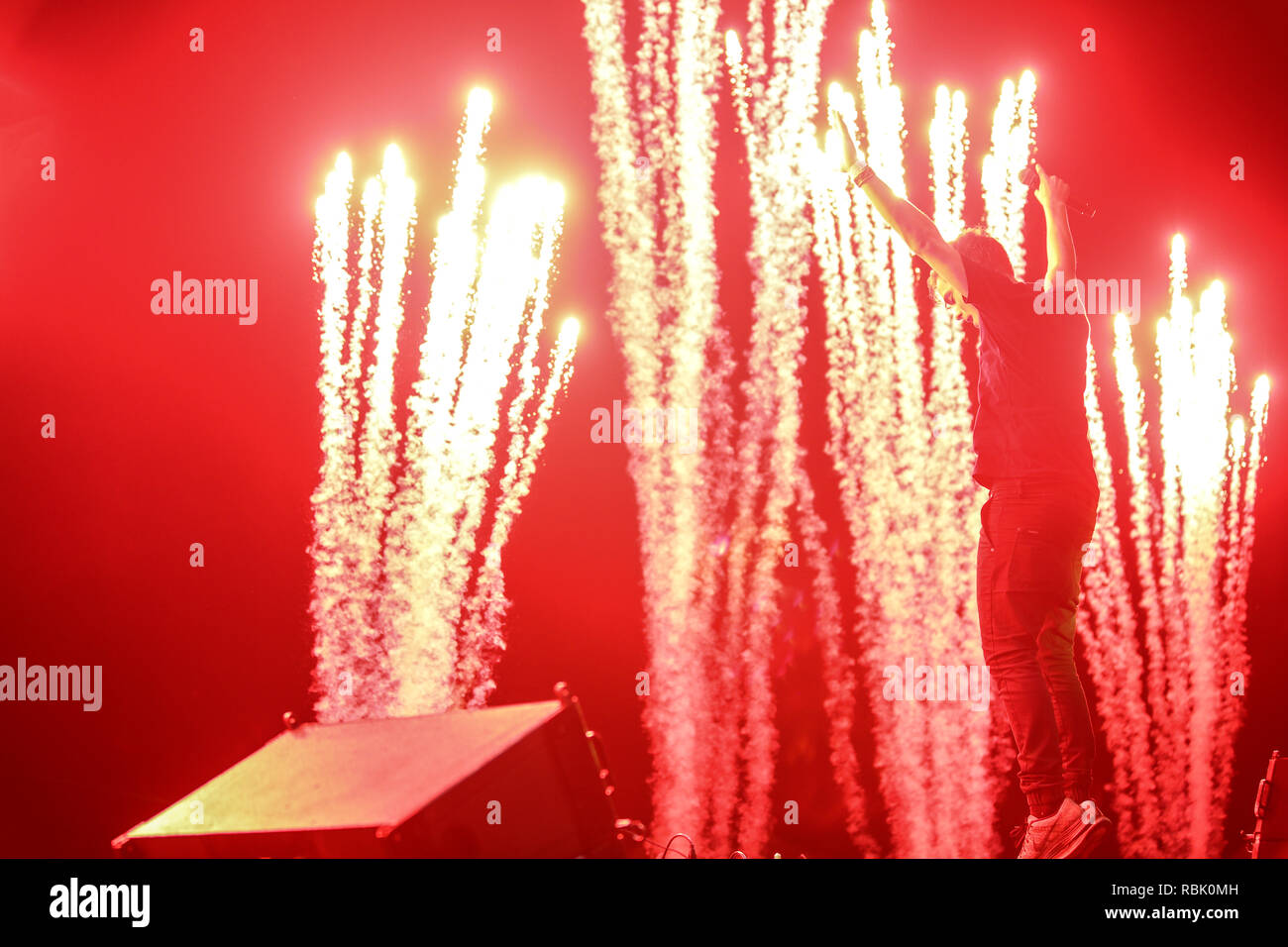 superstar dj martin garrix stands on the dj booth while fireworks is in ...