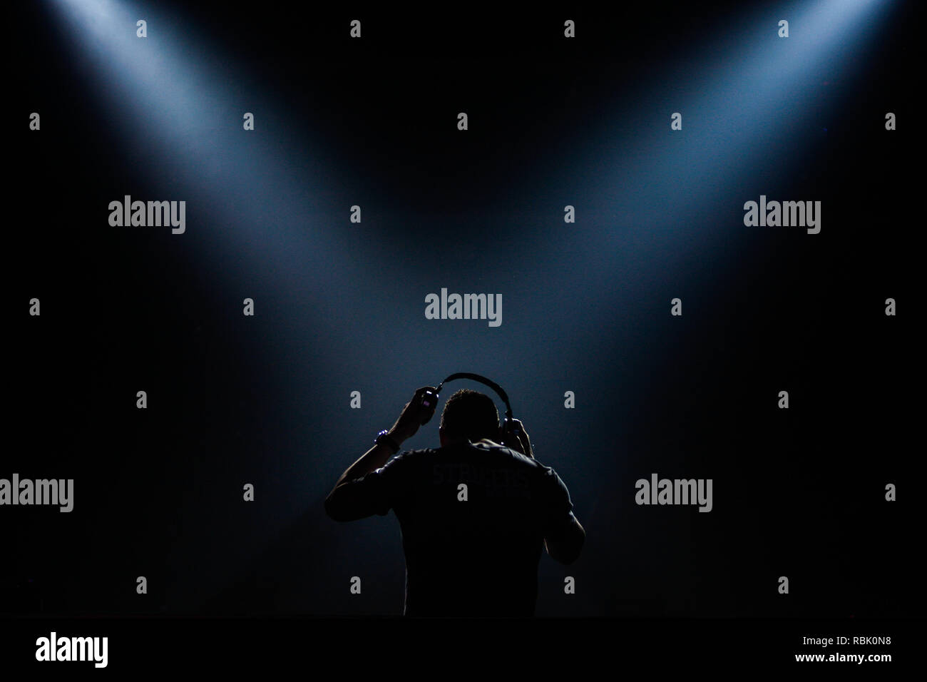 dj superstar tiesto adjusts his headphone while performing live Stock ...