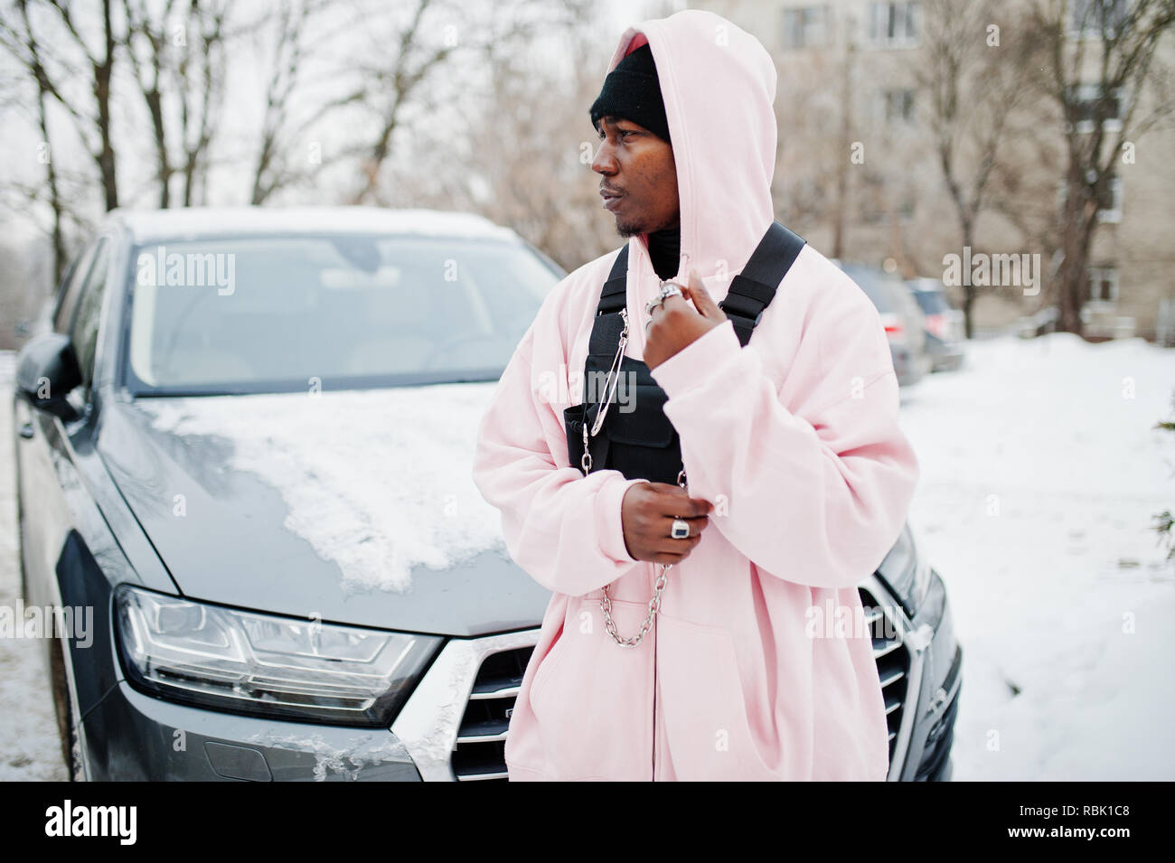 Stylish urban style african american man in pink hoodie posed against ...