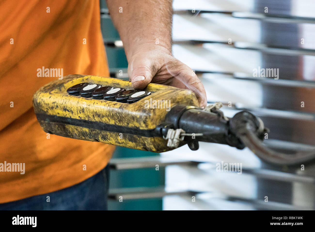A male worker operating an industrial remote switch Stock Photo - Alamy