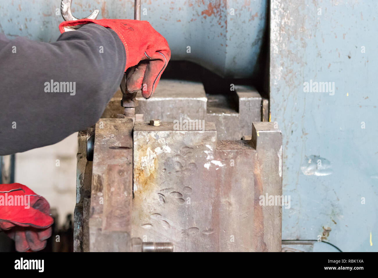 Detail of an male operator securing a profile die inside an aluminium ...