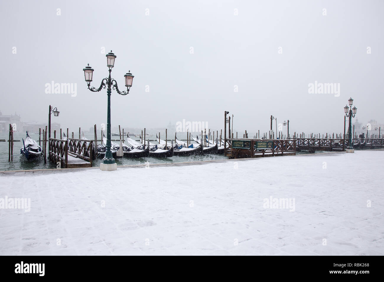 Snowing in Venice with traditional Venice gondolas on St. Mark square ...