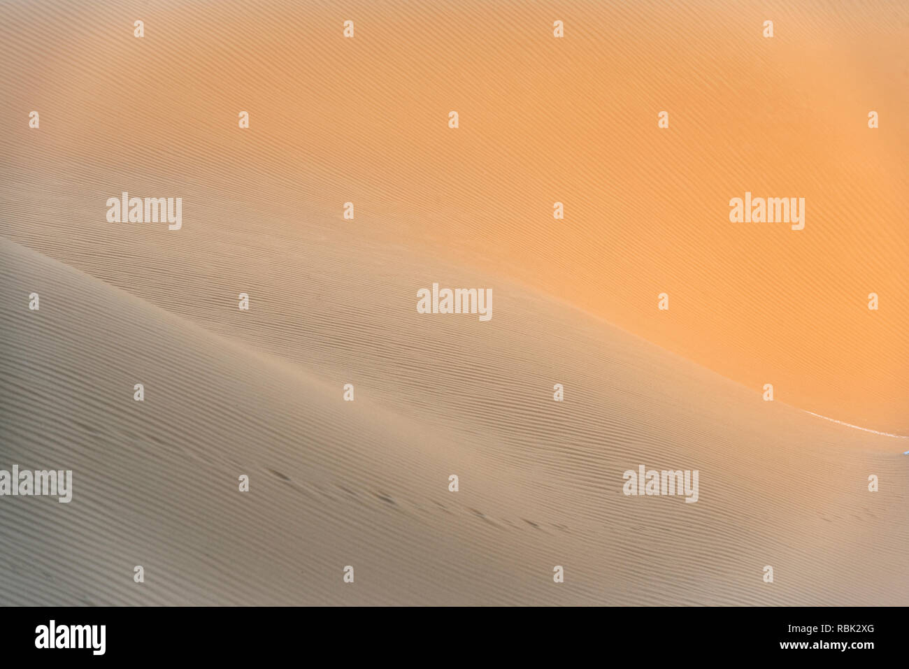 Abstract desert sand pattern shaped by low sunlight and wind formed ...