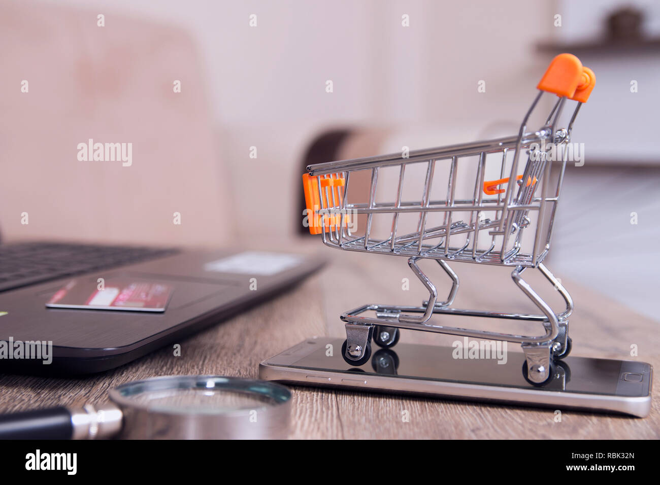Shopping cart on laptop computer Stock Photo - Alamy