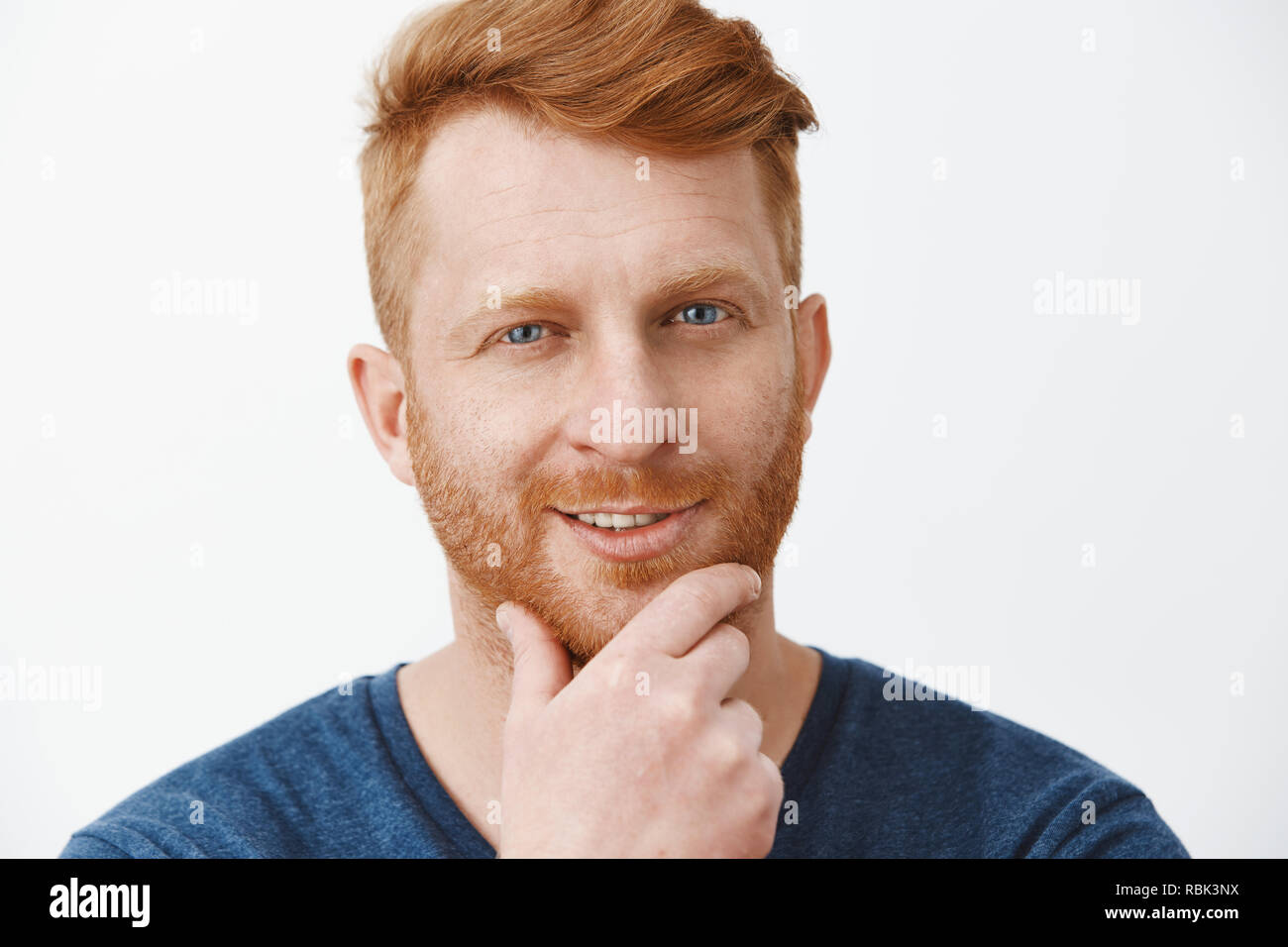 Headshot of creative and intrigued attractive redhead guy with bristle ...