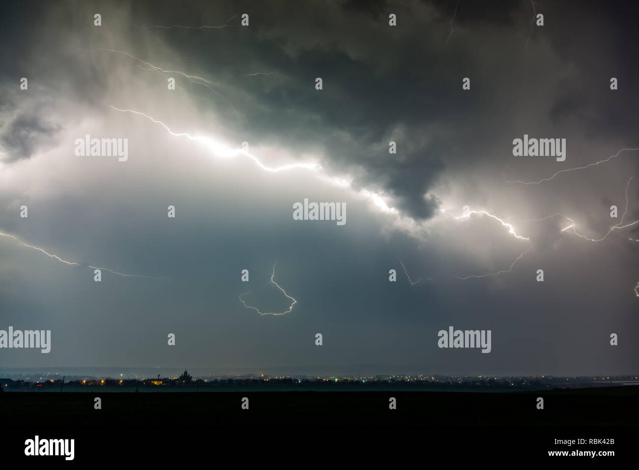 Lightnings over city during thunderstorm Stock Photo - Alamy