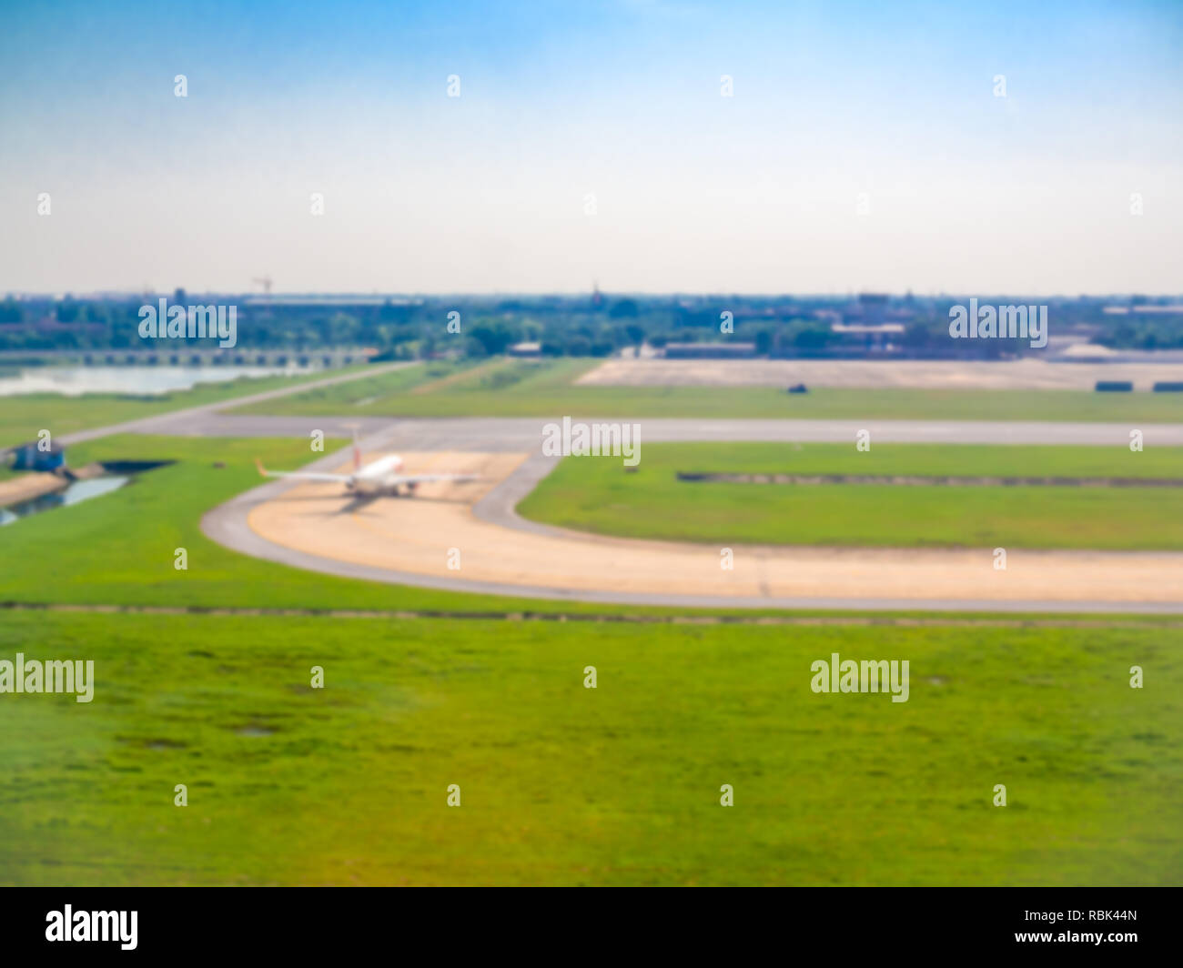Blurred of runway with airplane in airport. Airplane on the road with ...
