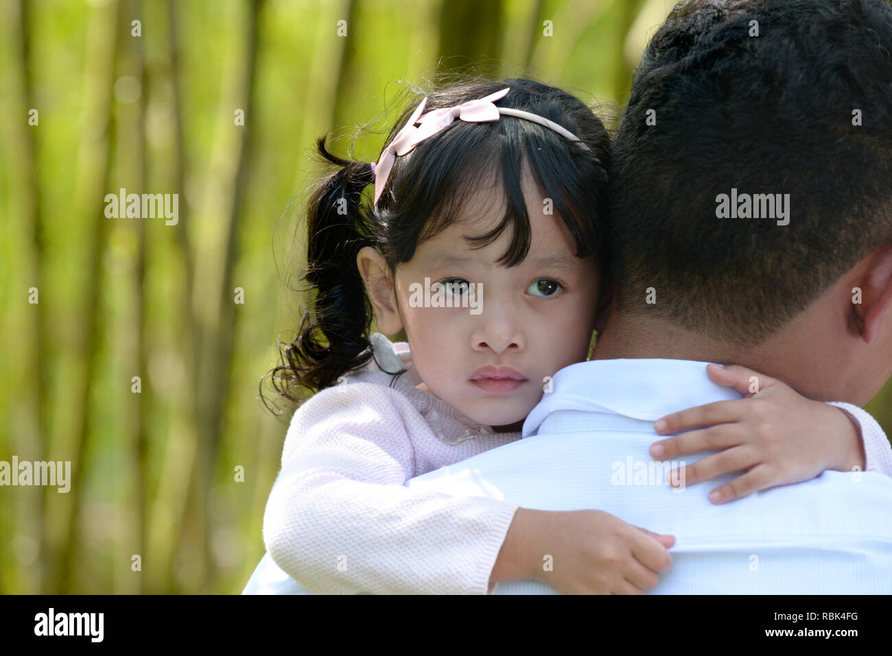 malay muslim father and moody looking daughter Stock Photo - Alamy