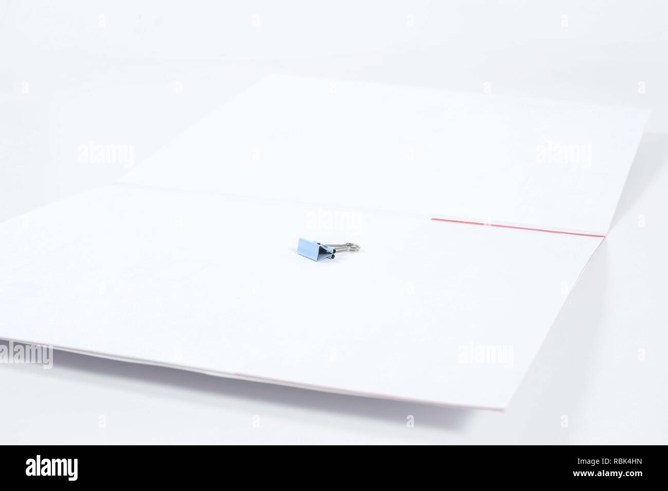 Picture of paper clip and magazine cover. Isolated on the white ...