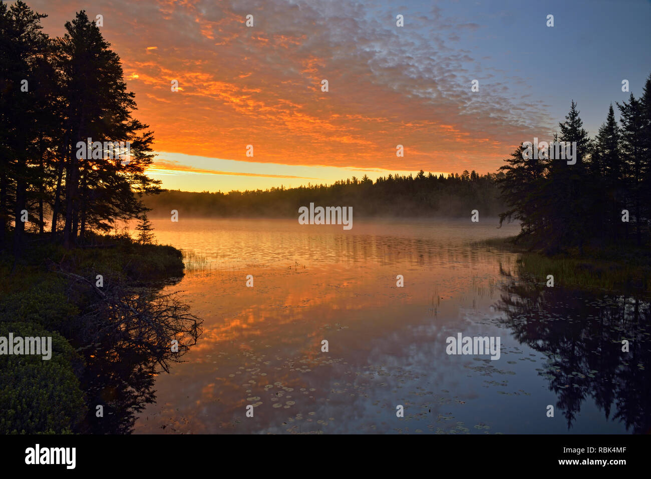 Sunrise sky reflected in Halfway Lake, Halfway Lake Provincial Park ...