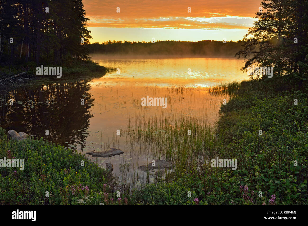 Sunrise sky reflected in Halfway Lake, Halfway Lake Provincial Park ...