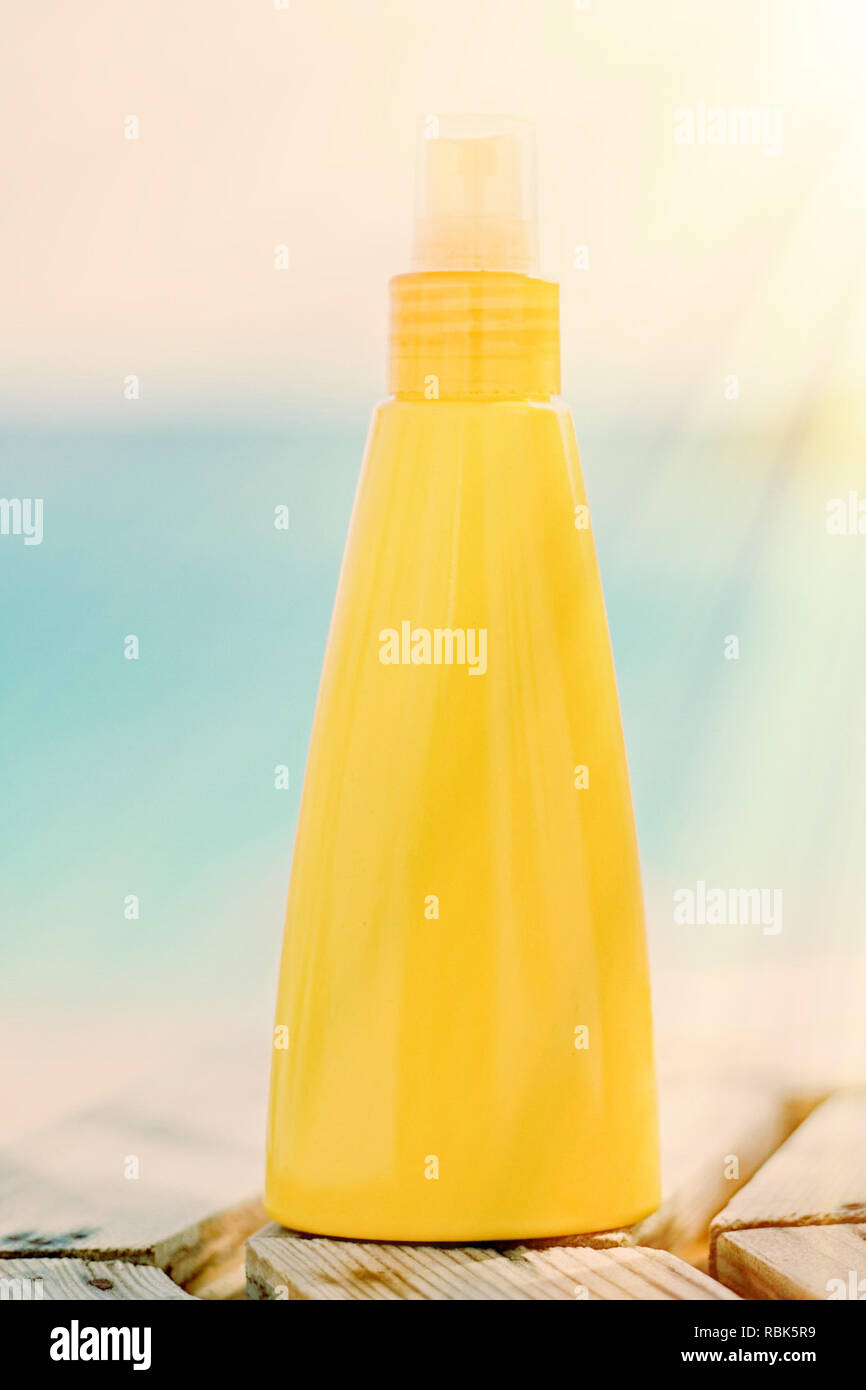 sun tan lotion on the beach - skincare cosmetics and holiday styled ...