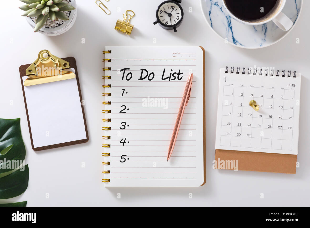 To do list in notebook with calendar and clock on white desk Stock ...