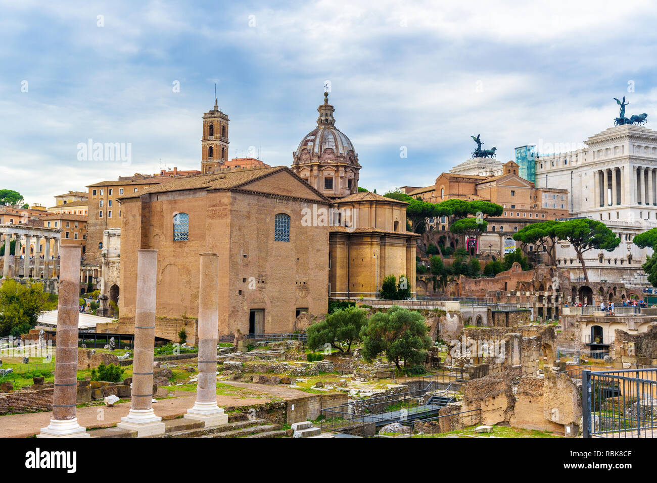 Ruins of Roman Forum. Curia Julia, Roman columns and church of Santi ...