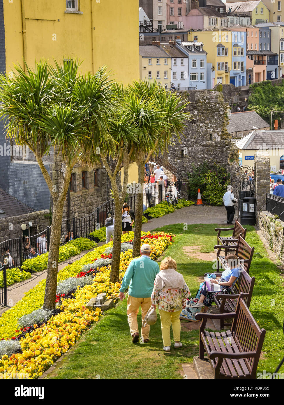 TENBY, PEMBROKESHIRE, WALES - AUGUST 2018: People in a small garden ...
