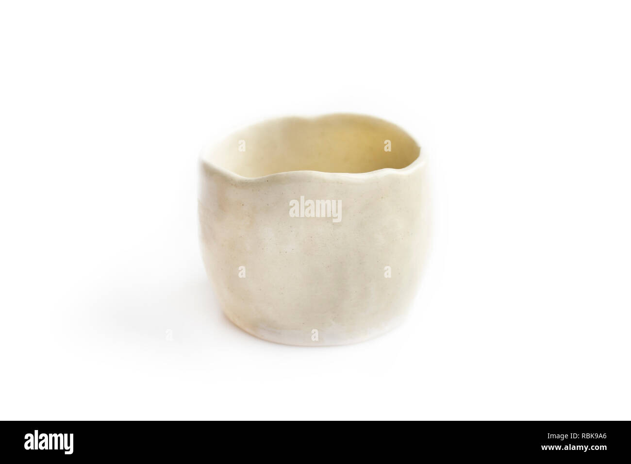 Clay cup, made by hand from white clay. Double burning. Transparent ...
