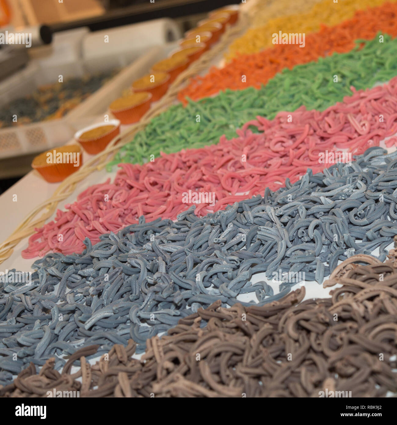 Display of a Food Store with Various Rows of Raw Coloured Pasta Stock ...