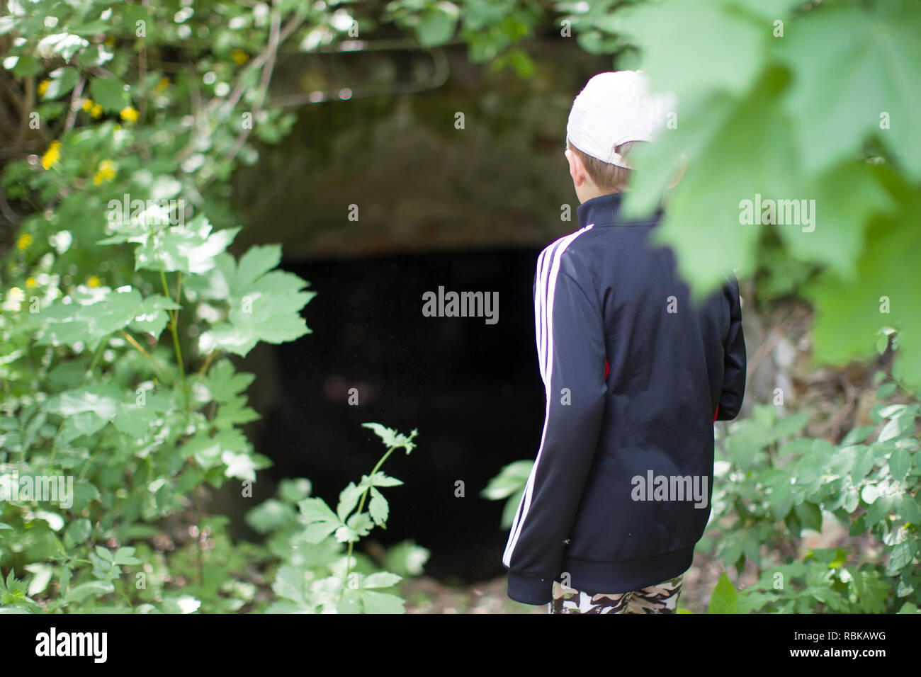 A little boy looks into the abyss. Baby curiosity. The child is ...