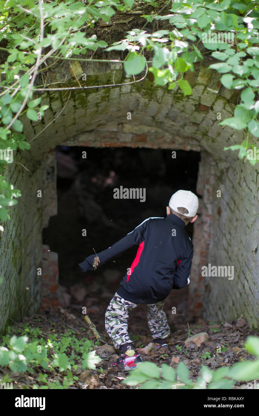 A little boy looks into the abyss. Baby curiosity. The child is ...