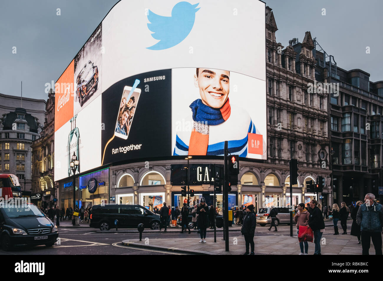 London, UK - January 5, 2019: People walking in front of big digital ...