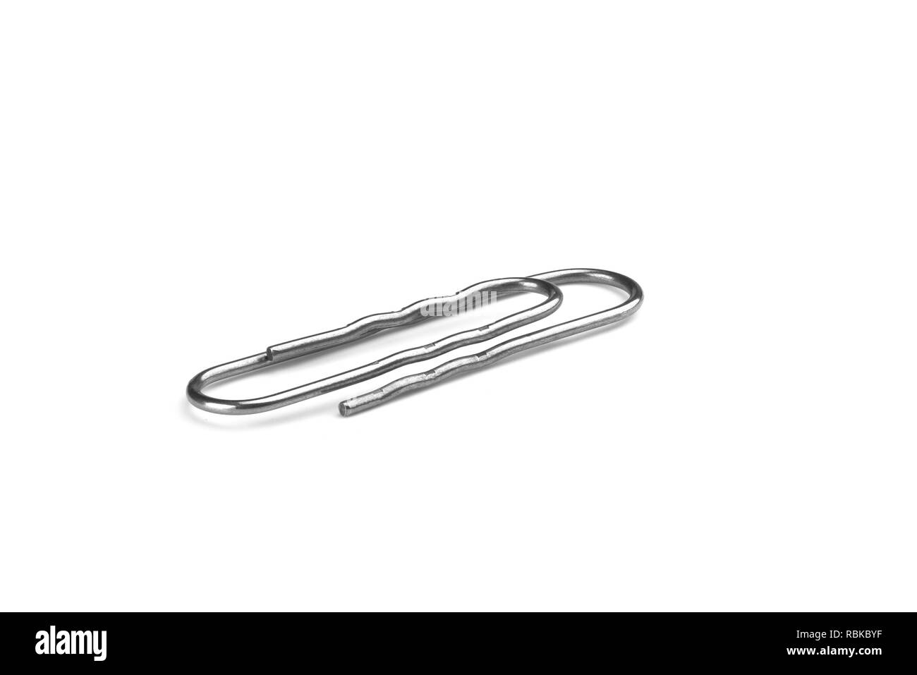 Steel paper clip isolated on white background. Copy space. Close up ...