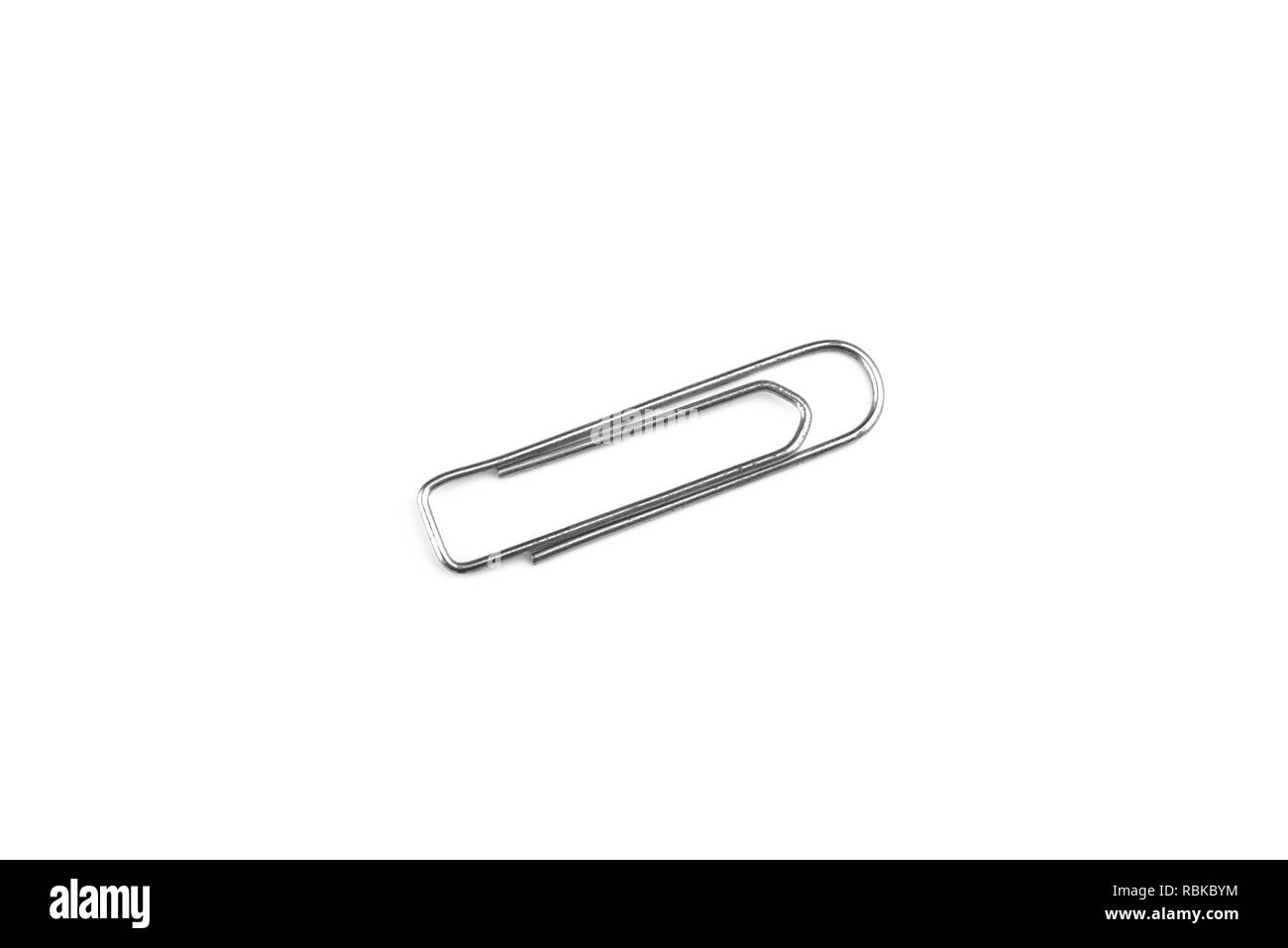 Old steel paper clip isolated on white background. Copy space. Close up ...