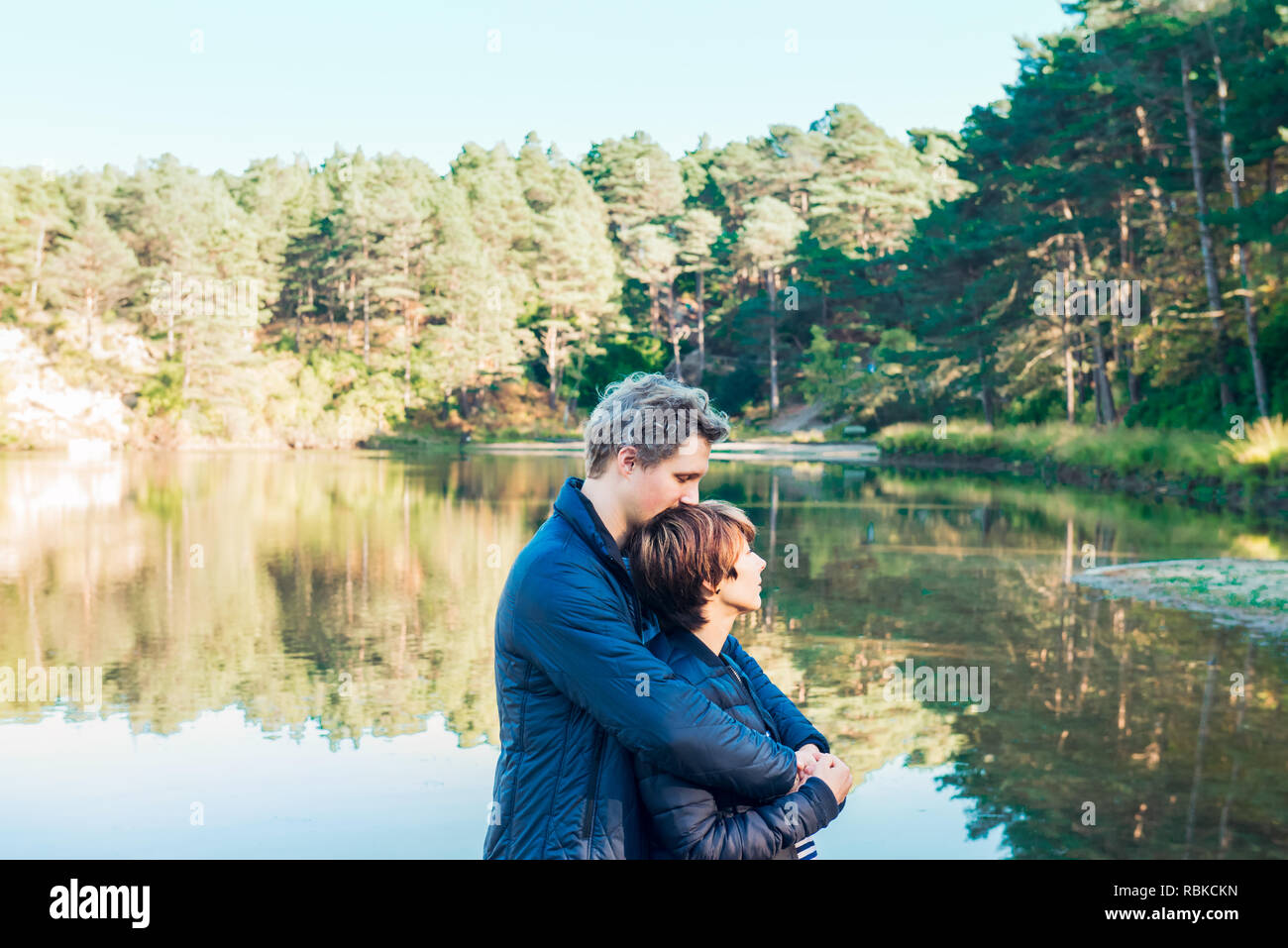Two attractive dreamy people, couple in casual outfit at wild forest ...