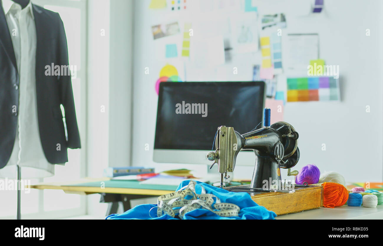 Retro sewing machine on designer clothes desktop Stock Photo - Alamy