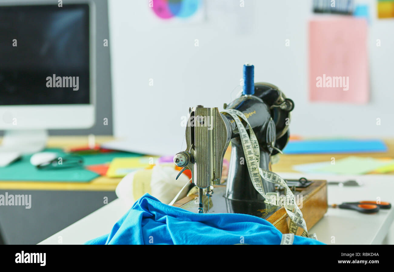 Retro sewing machine on designer clothes desktop Stock Photo - Alamy