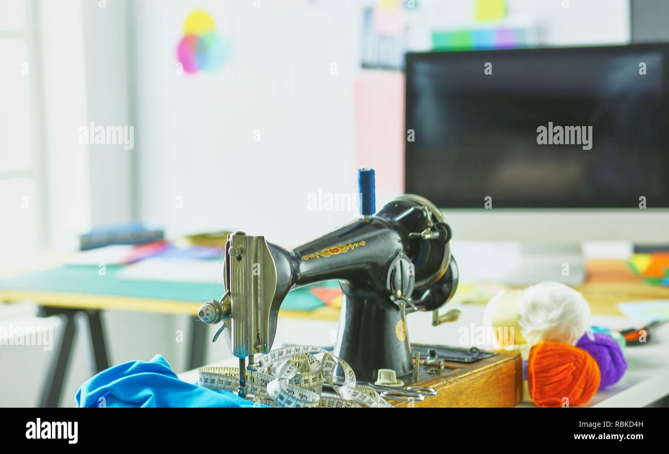 Retro sewing machine on designer clothes desktop Stock Photo - Alamy