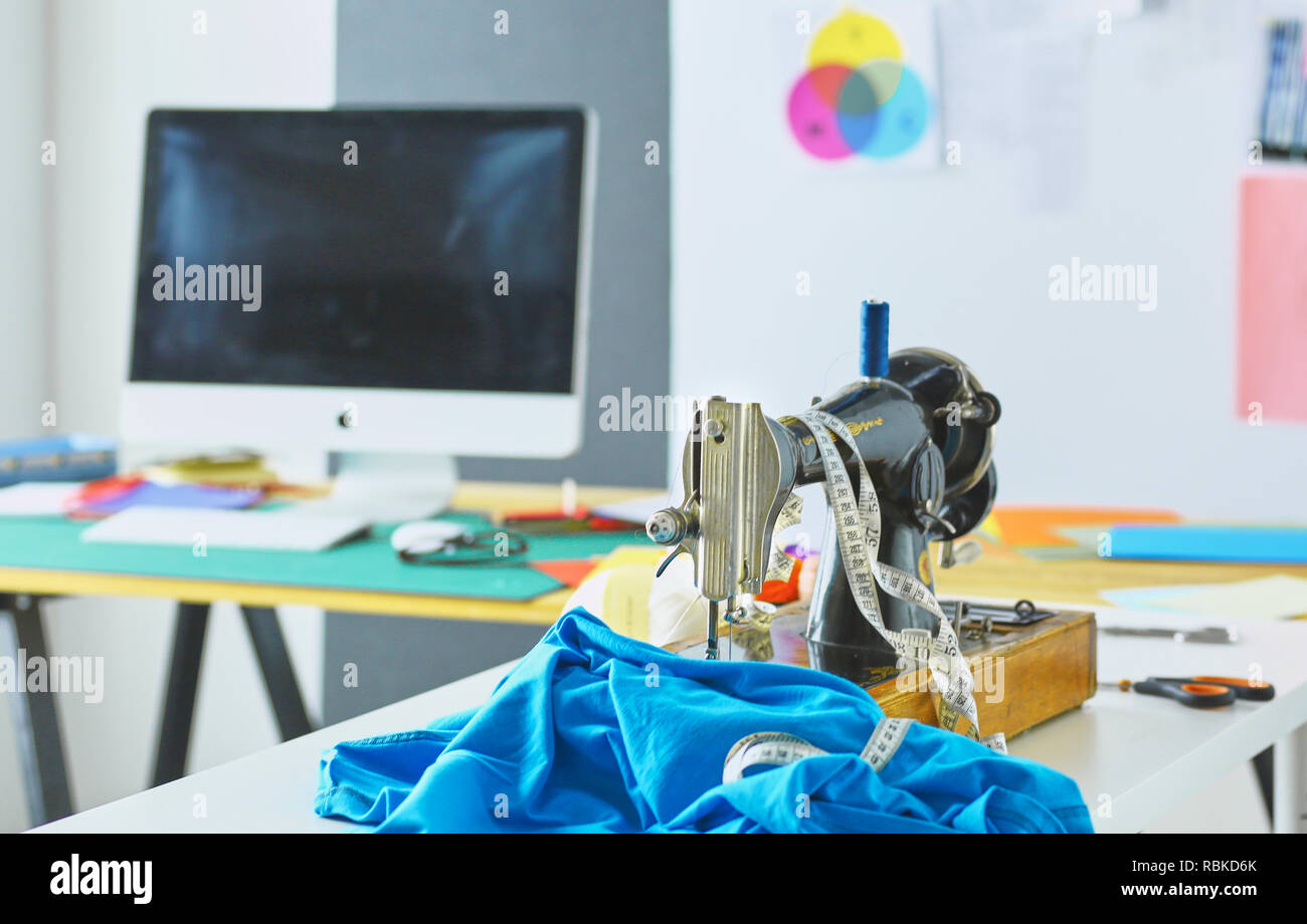 Empty workroom and workplace of tailor or vendor of clothes in small ...