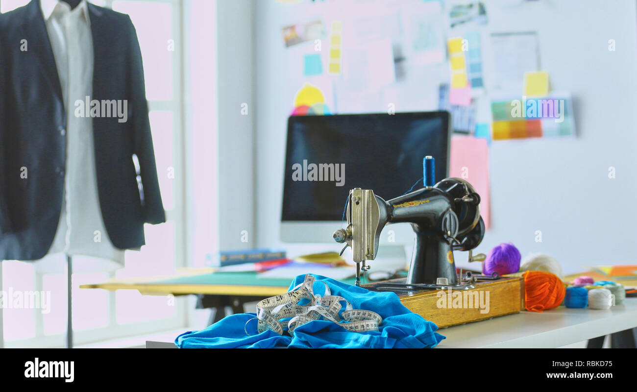 Empty workroom and workplace of tailor or vendor of clothes in small ...