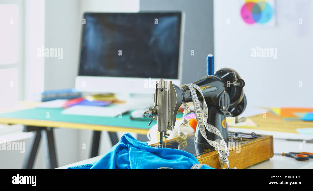 Empty workroom and workplace of tailor or vendor of clothes in small ...
