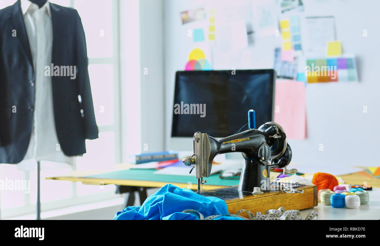 Empty workroom and workplace of tailor or vendor of clothes in small ...