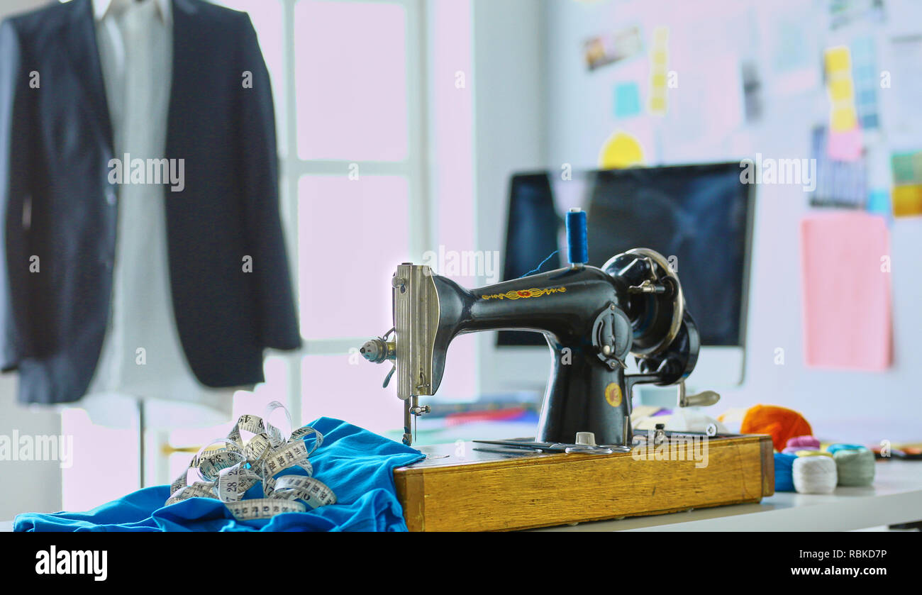 Empty workroom and workplace of tailor or vendor of clothes in small ...