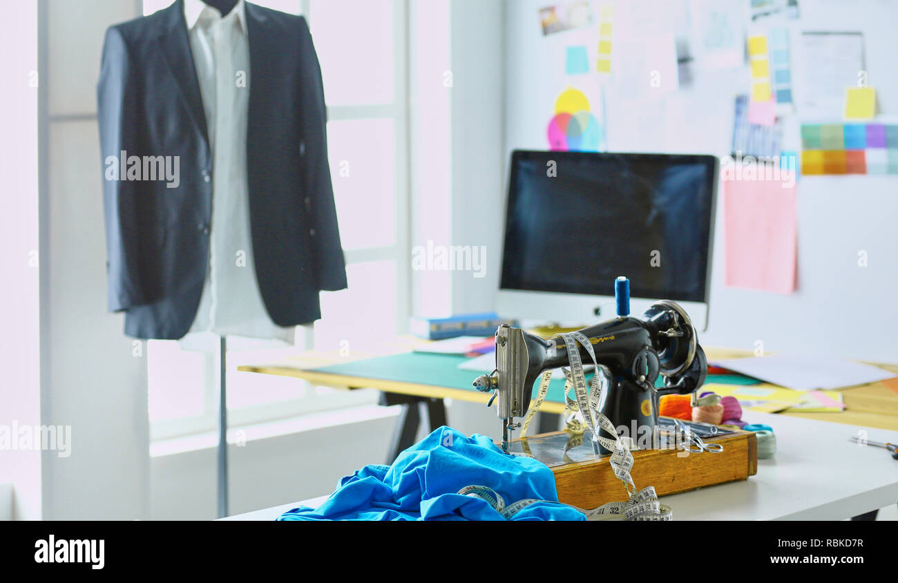Empty workroom and workplace of tailor or vendor of clothes in small ...