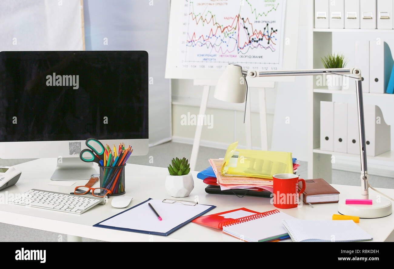 Workplace with notebook laptop Comfortable work table in office windows ...