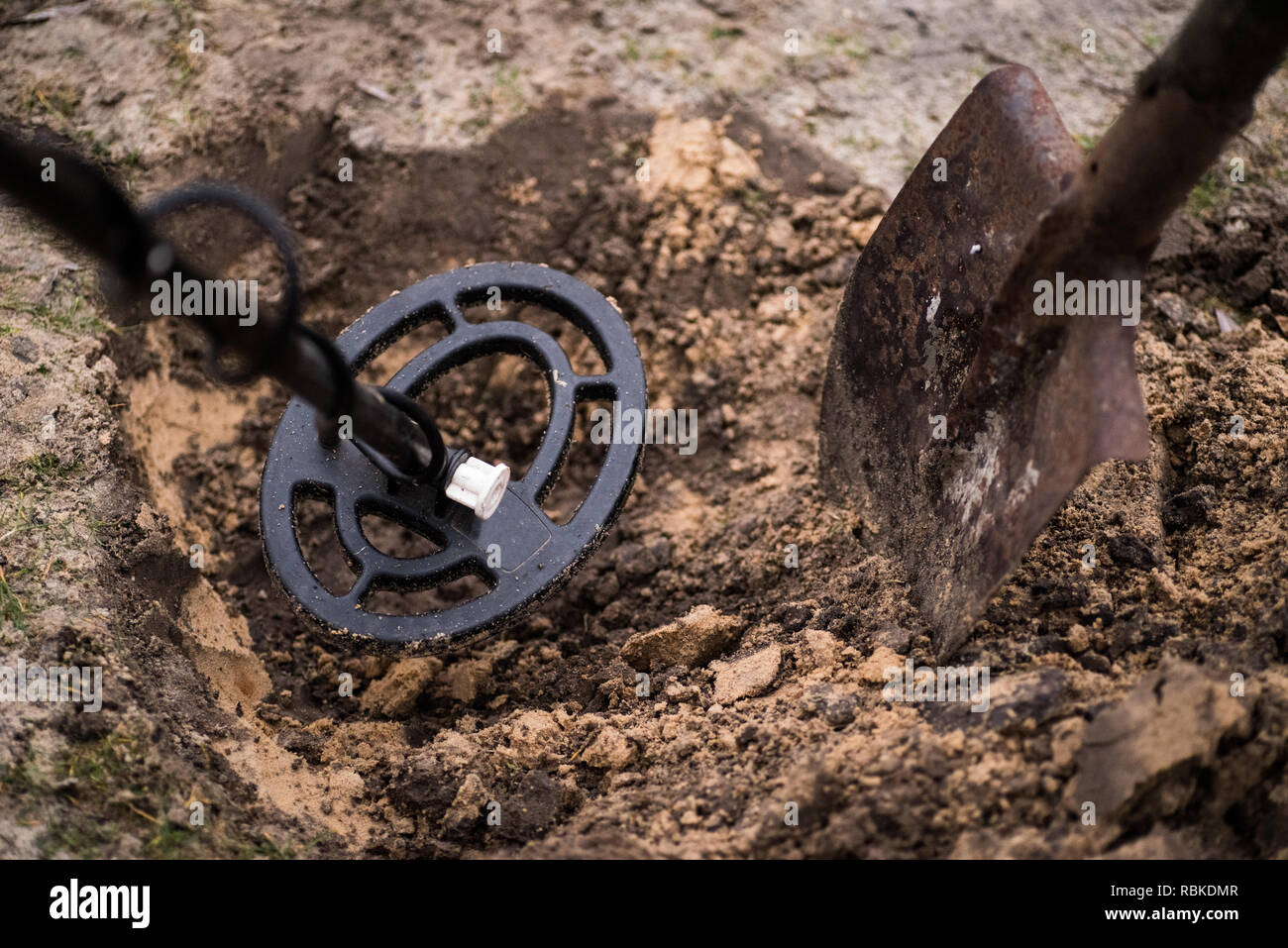 Black round metal detector. Metal detector on the ground.Metal shovel ...