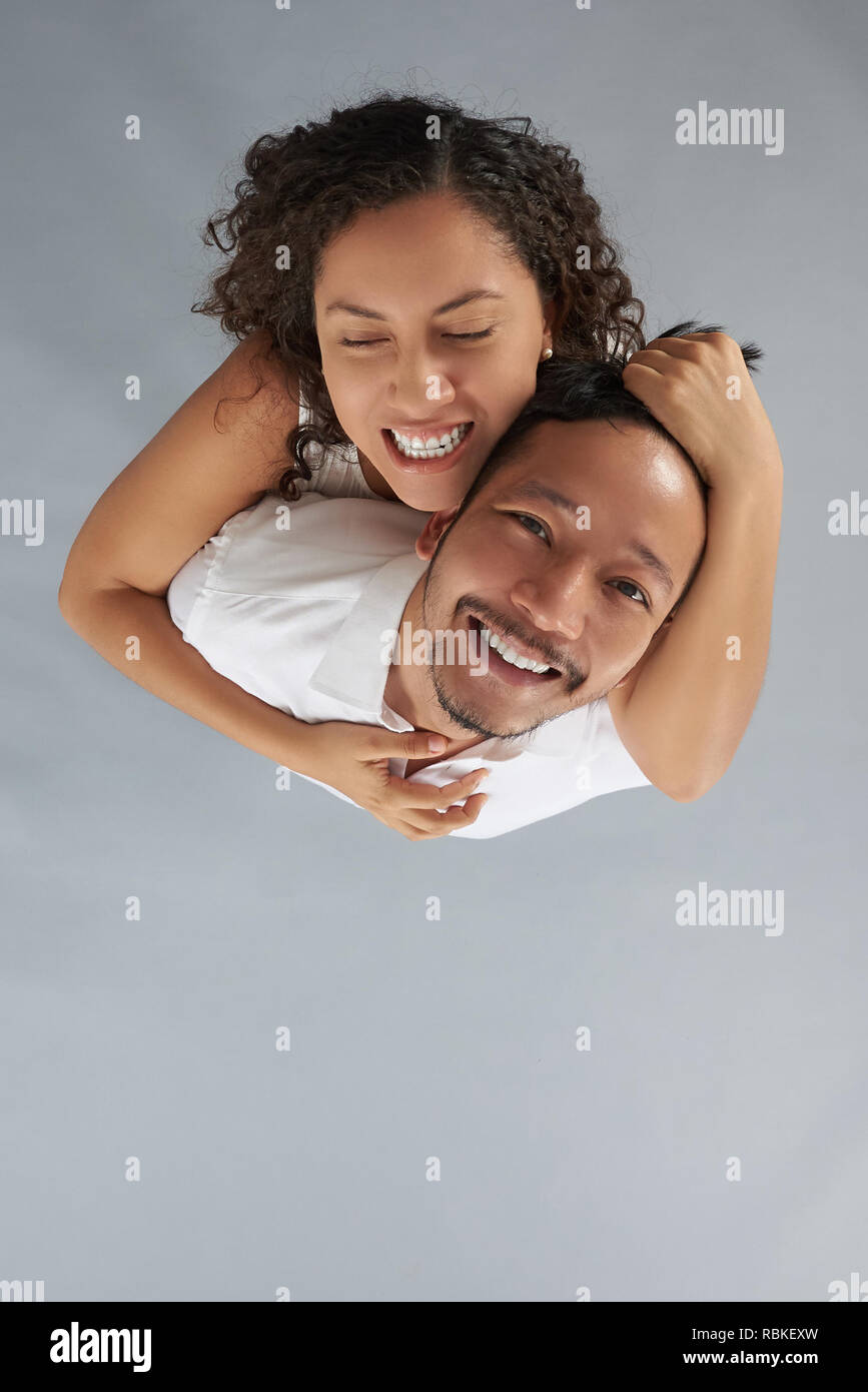 Young woman obsessed with man above top view on gray studio background ...