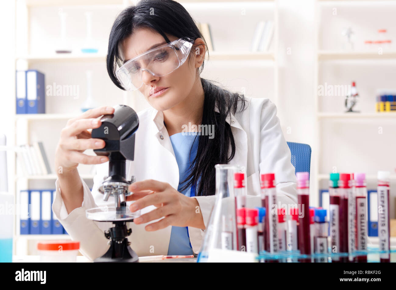 Female chemist working at the lab Stock Photo - Alamy