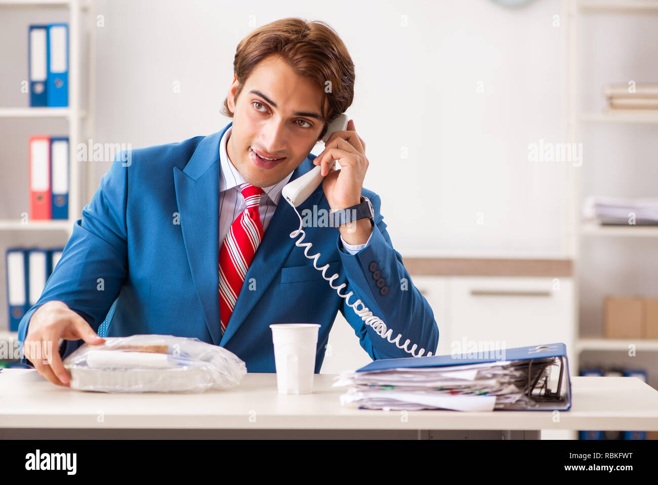 Man having meal at work during break Stock Photo - Alamy