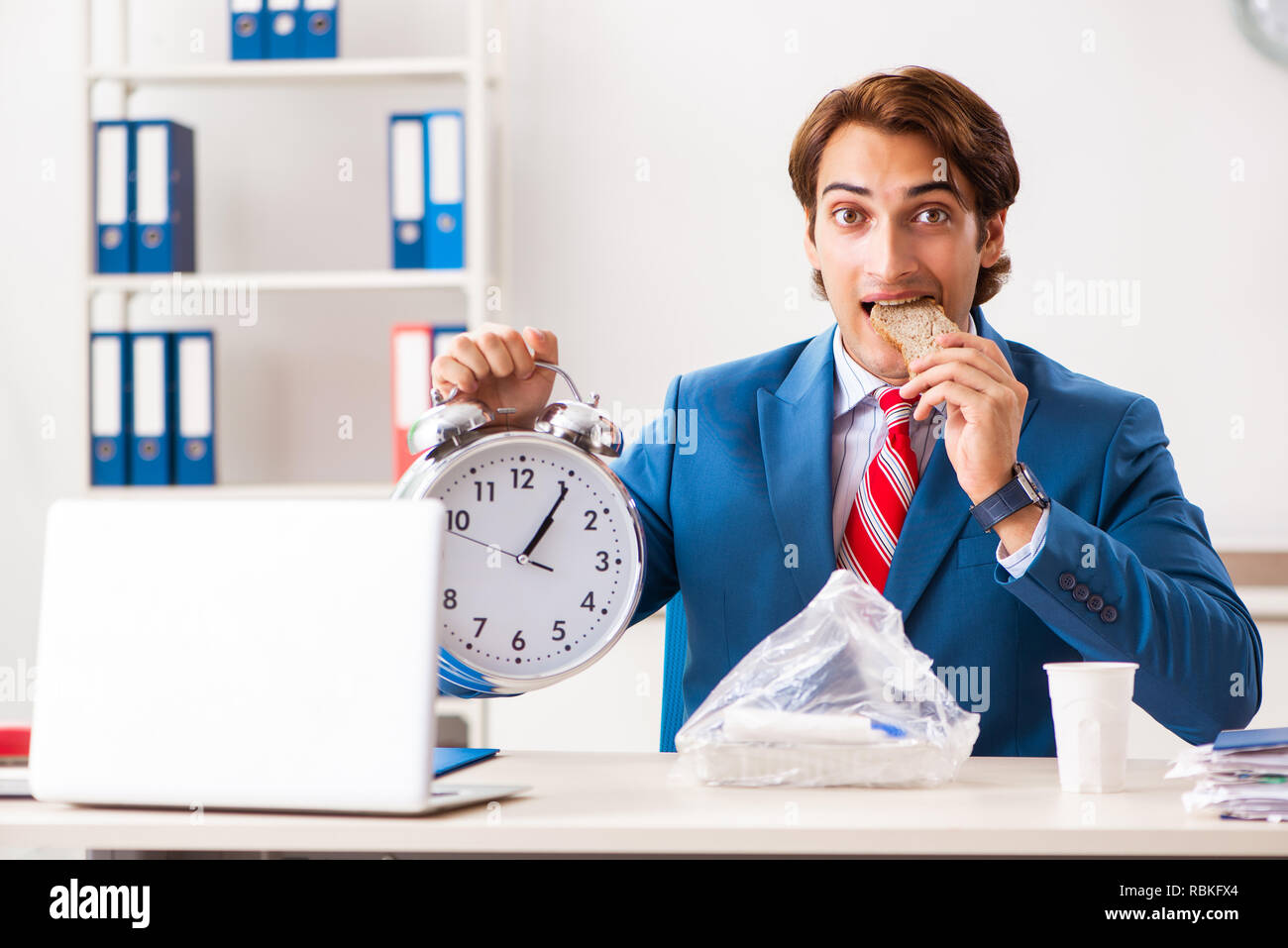 Man having meal at work during break Stock Photo - Alamy