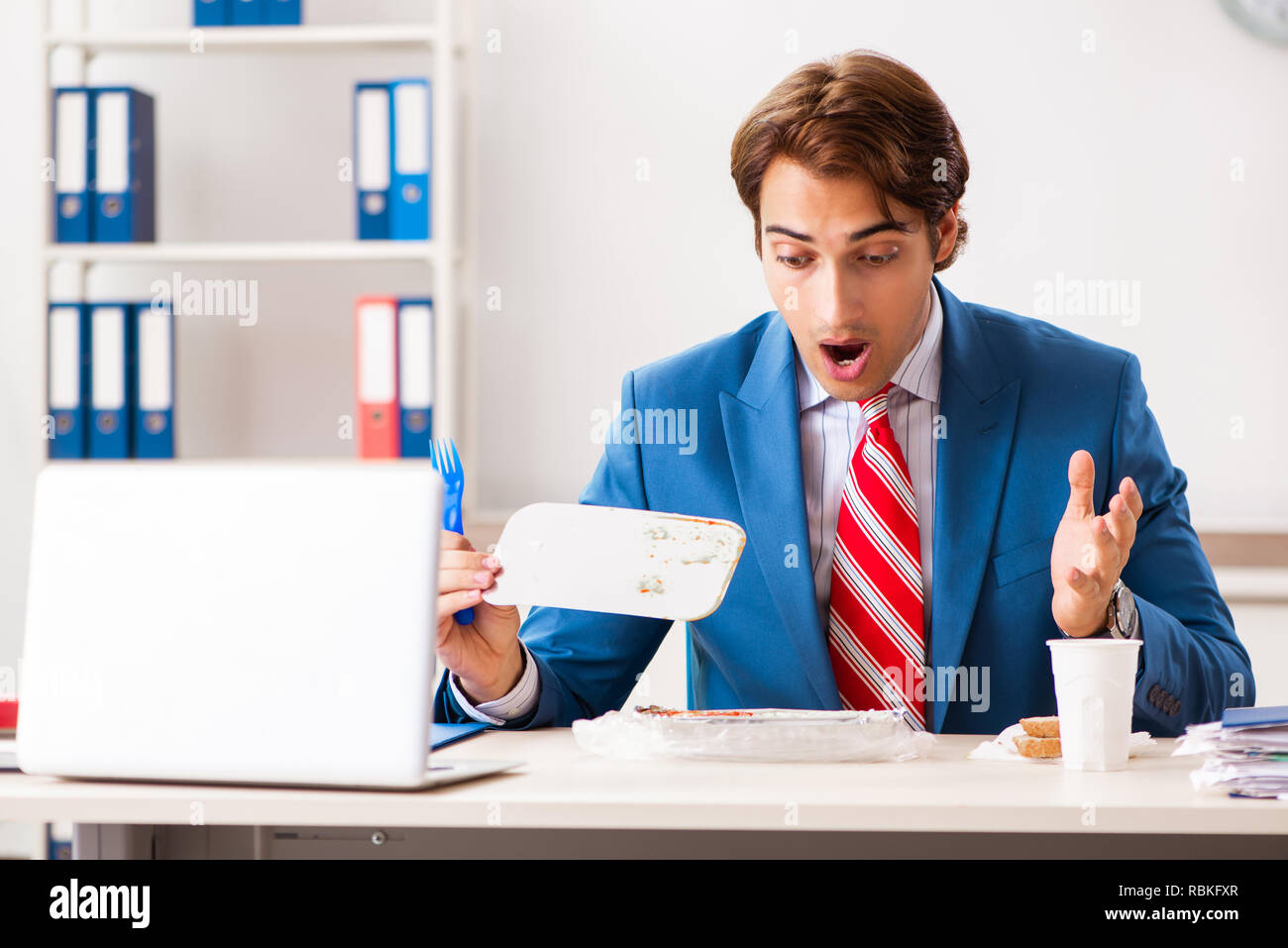 Man having meal at work during break Stock Photo - Alamy