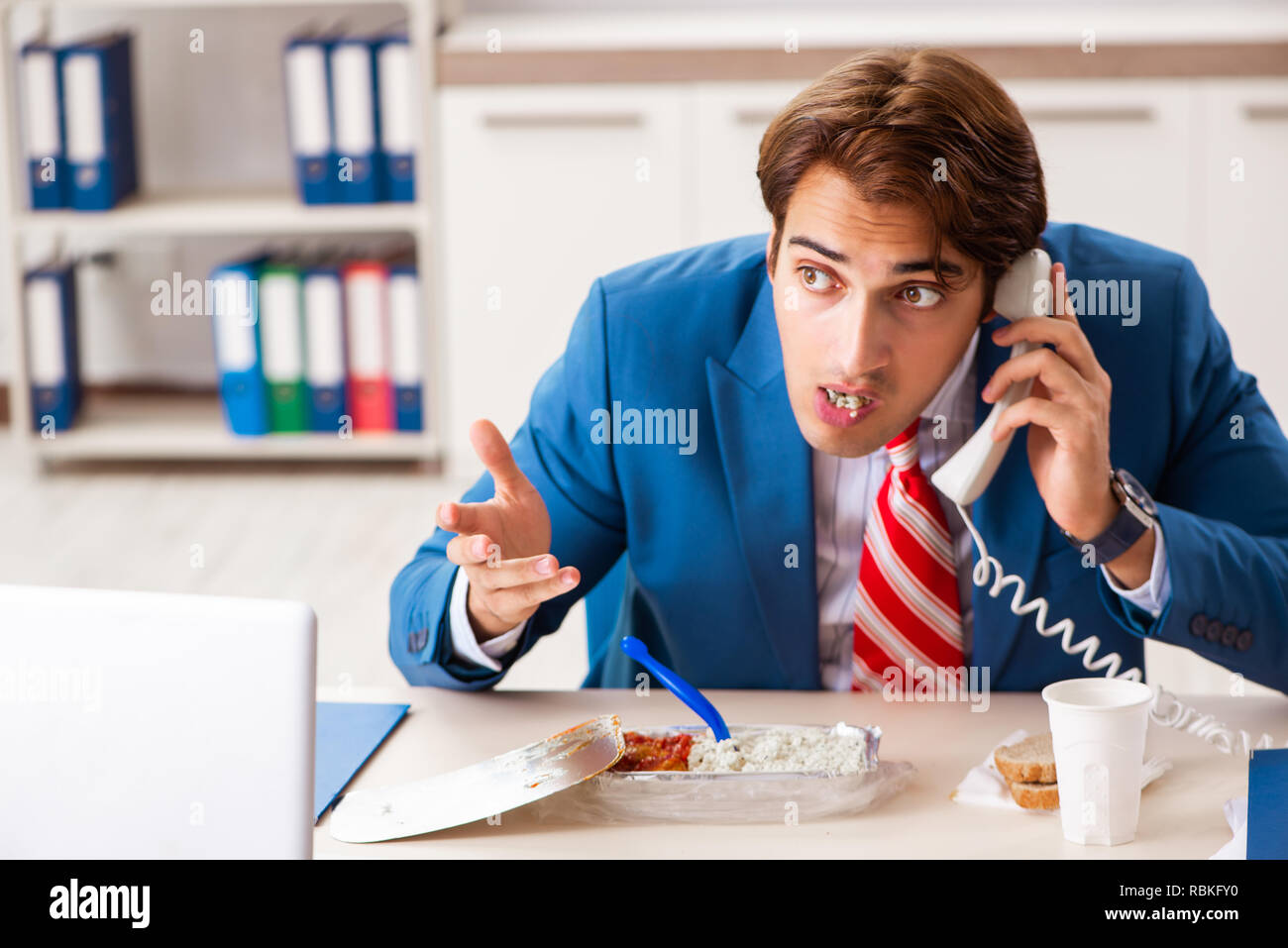 Man having meal at work during break Stock Photo - Alamy