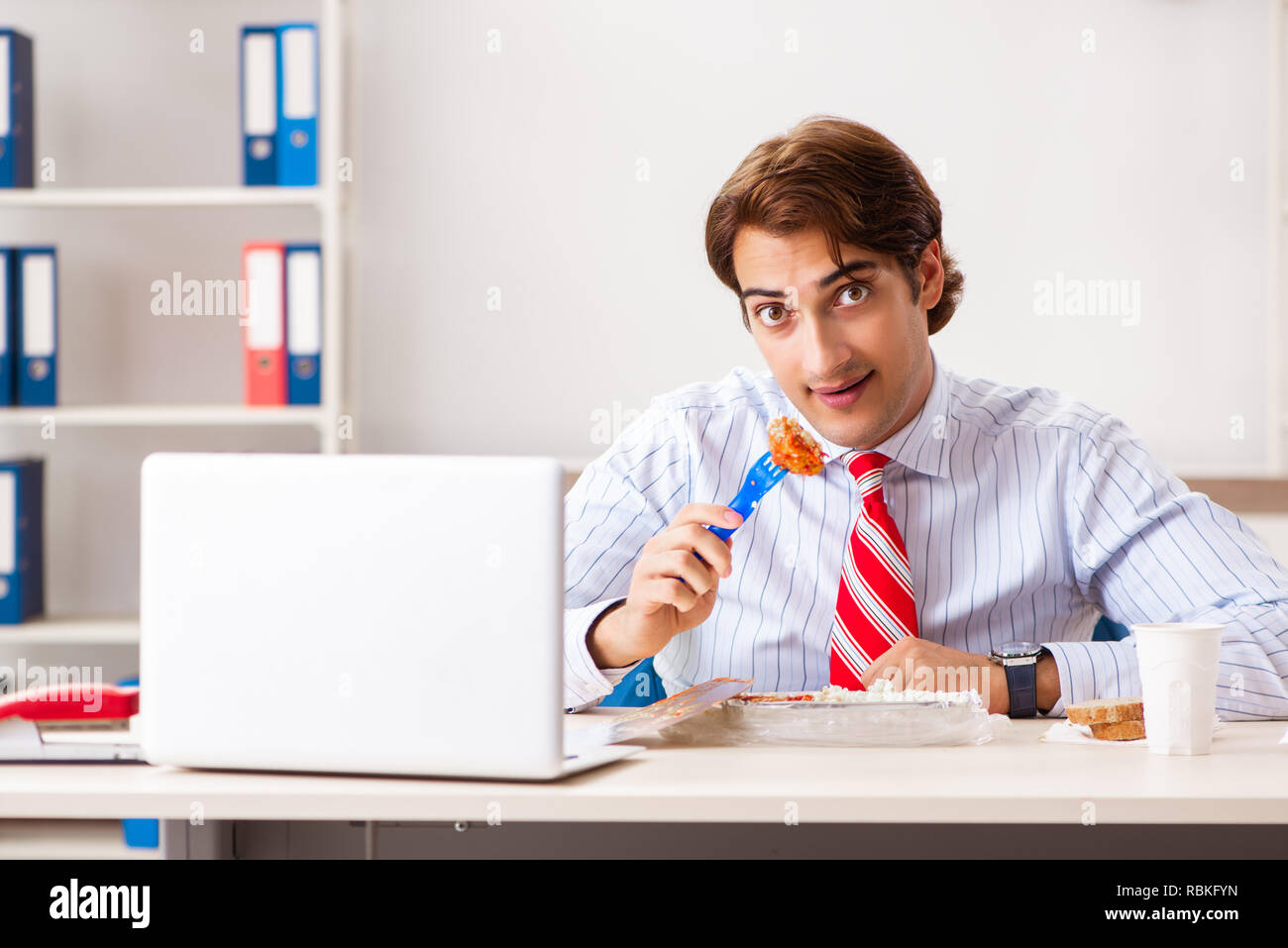 Man having meal at work during break Stock Photo - Alamy