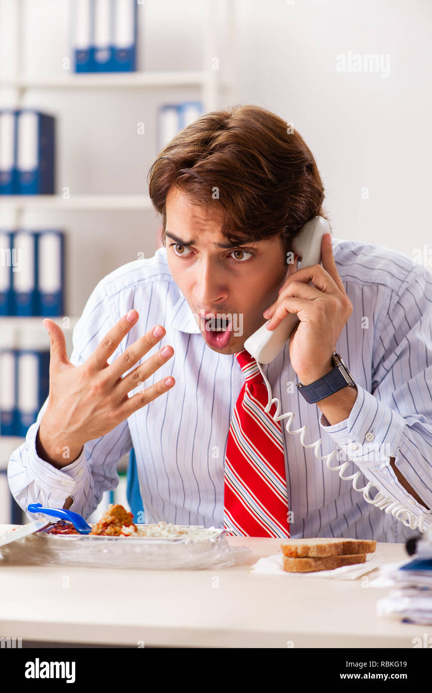 Man having meal at work during break Stock Photo - Alamy