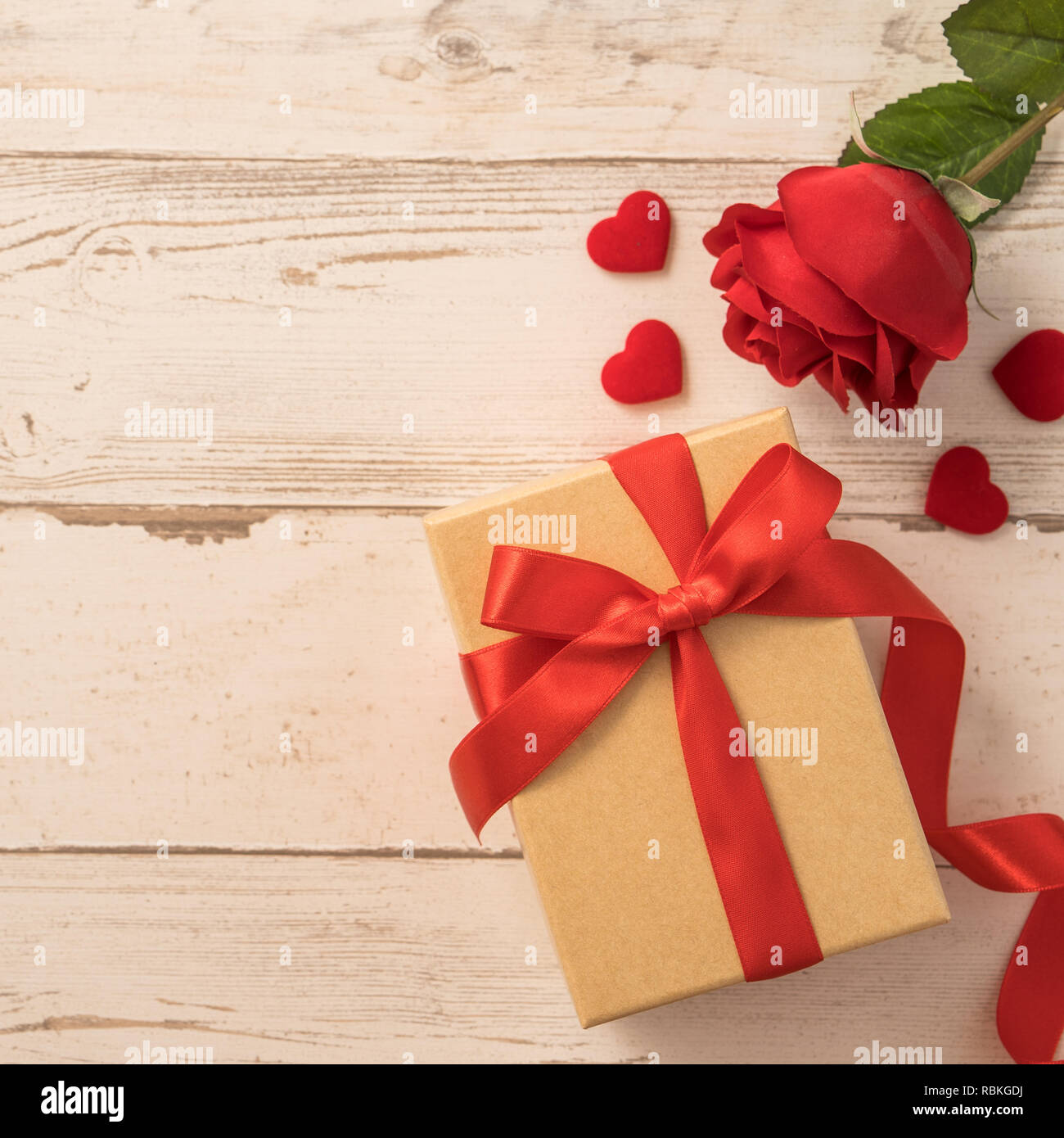 Kraft gift box with red ribbon bow, concept of giving present and ...