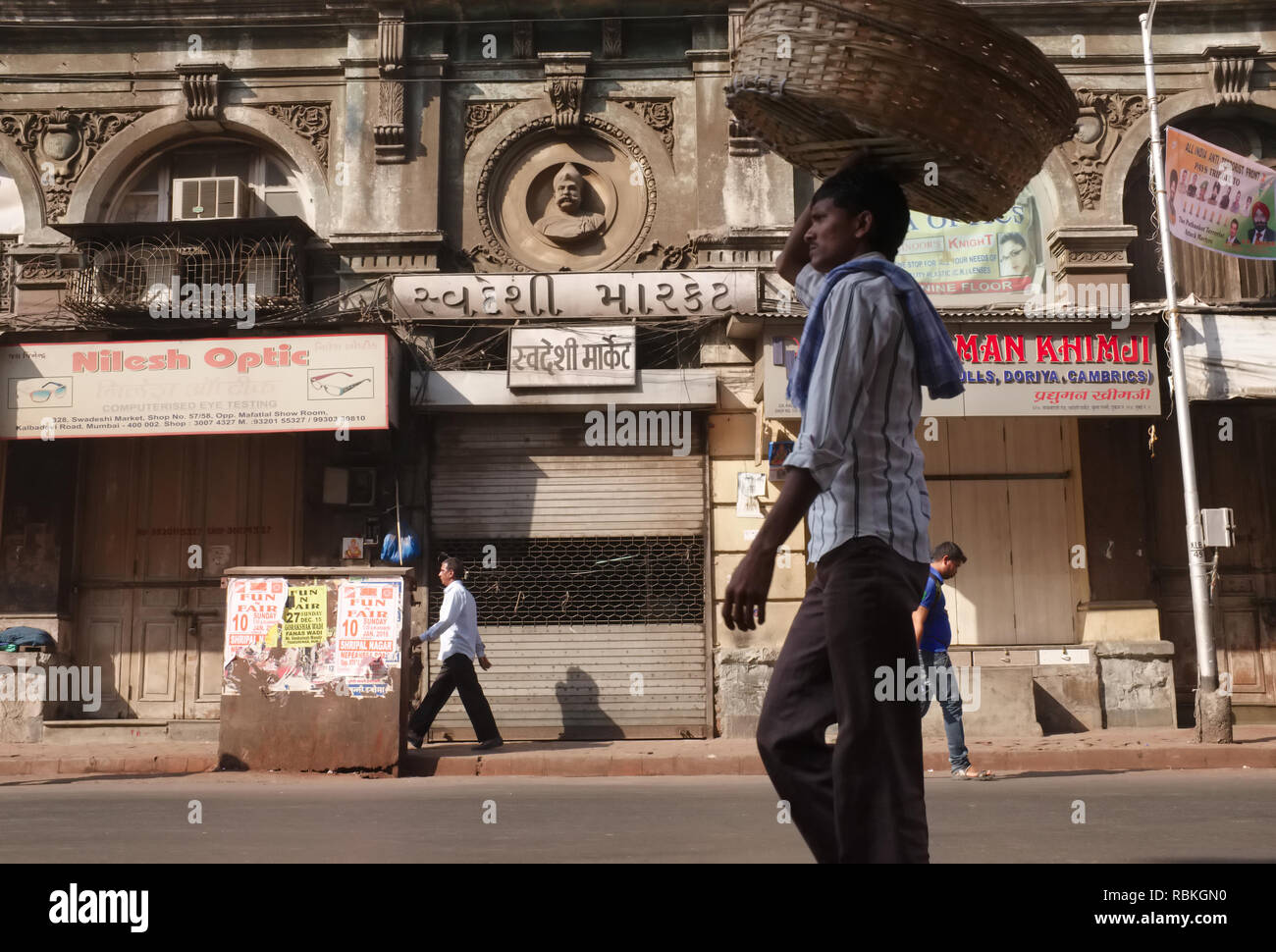 A porter passes through Kalbadevi Road, a centre of the textile trade ...