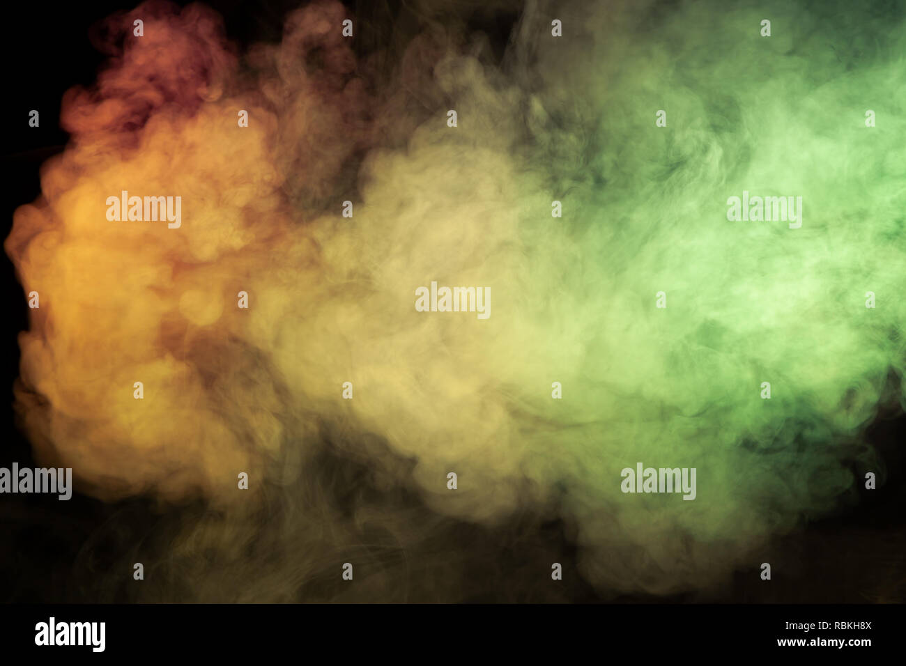 Multicolored smoke of red yellow and green colors from a vap scattering ...