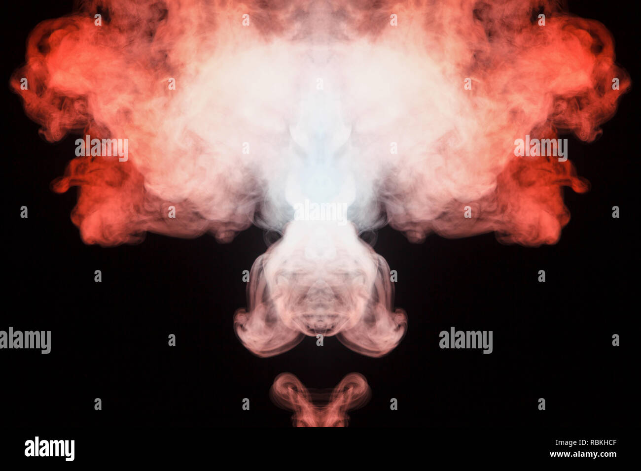 Mystical pattern of colored smoke of red and white in the shape of a ...